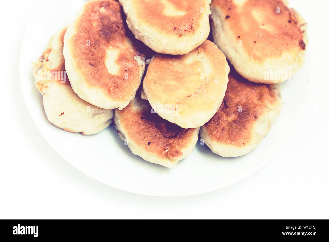 Fried cakes with potato and beans on white table background Stock Photo ...