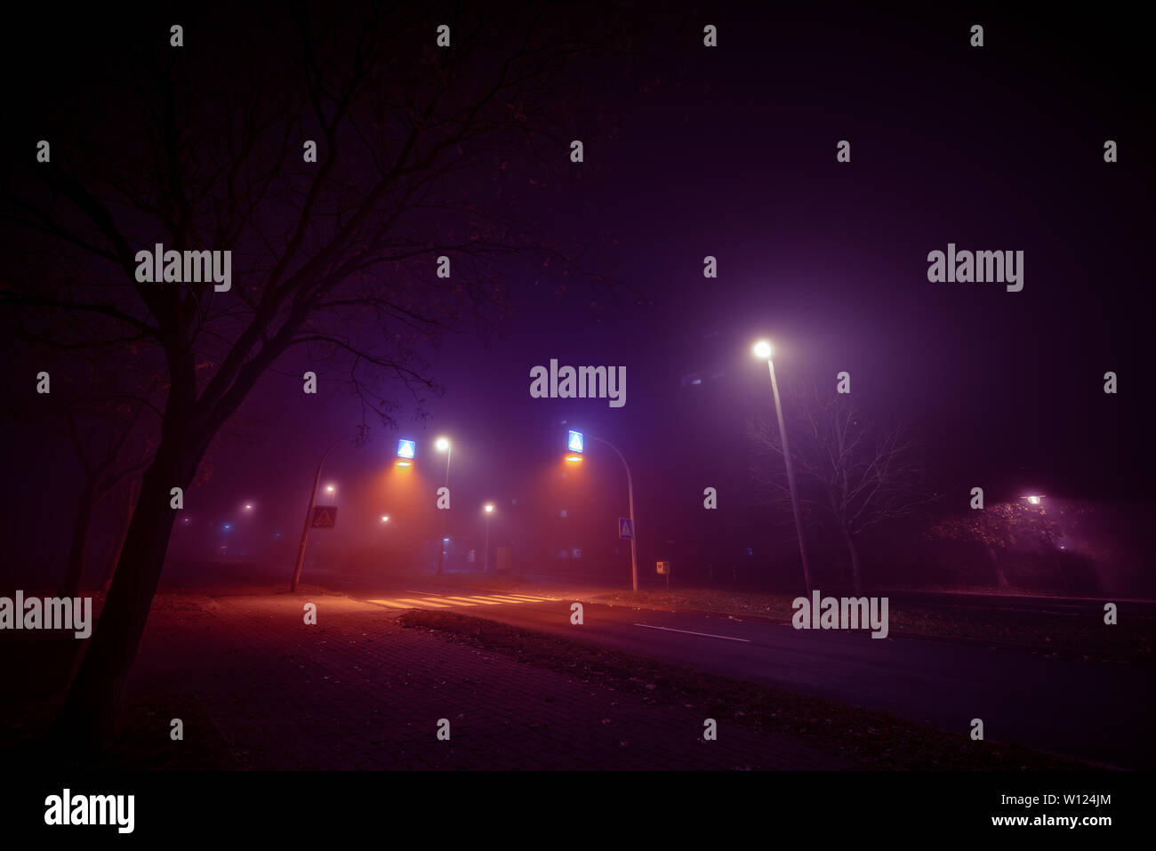 Fog at the crossroads in the night city Stock Photo - Alamy