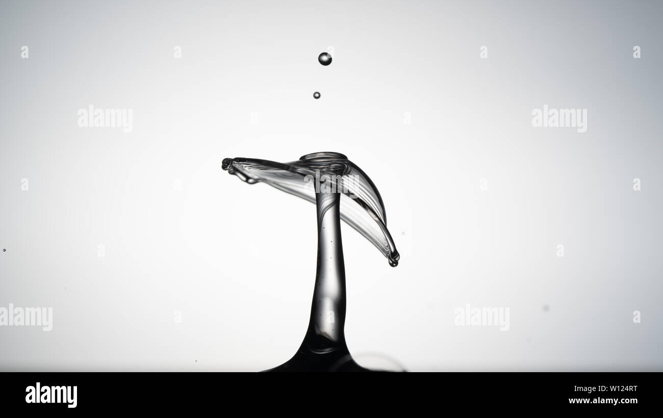 Close-up of a water drop falling on water surface Stock Photo - Alamy
