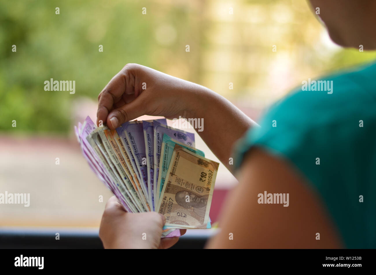 An Indian women holding all the colorful new released Indian Rupees ...