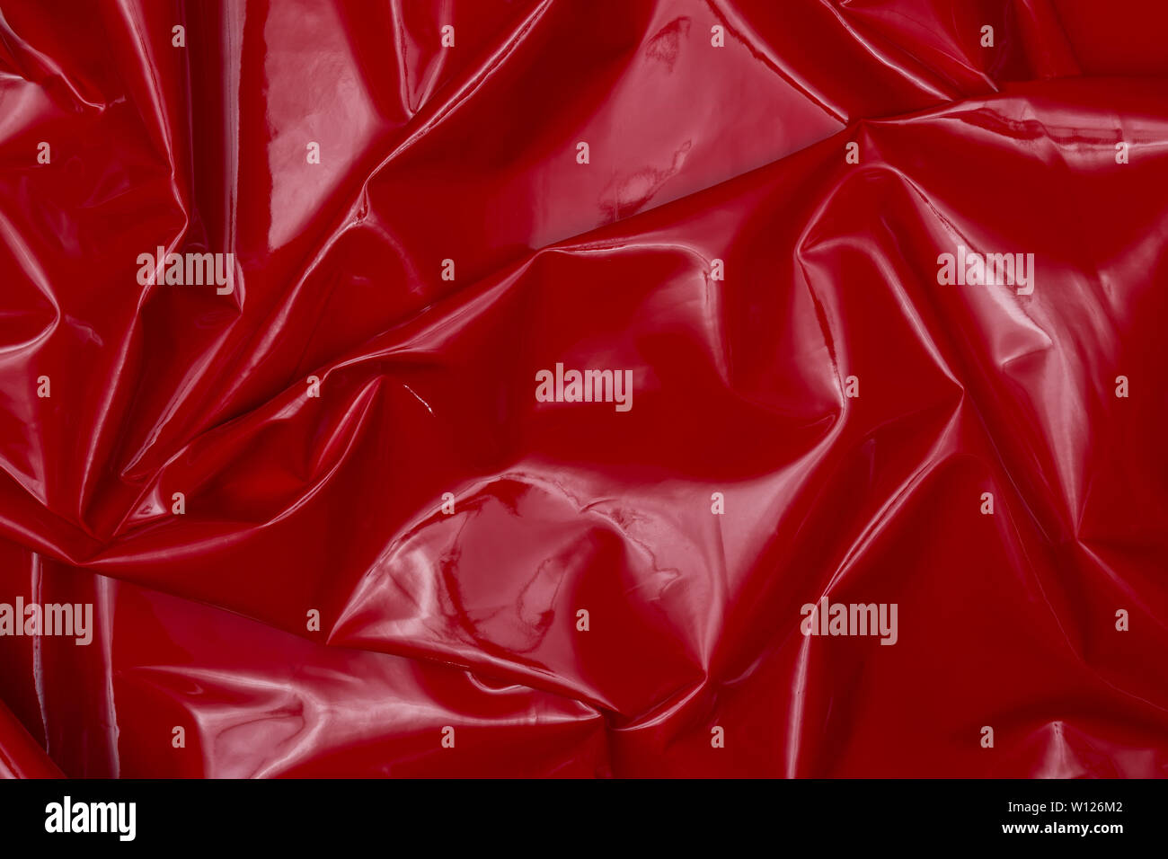 Beautiful closeup of red shiny fabric with textile texture background ...
