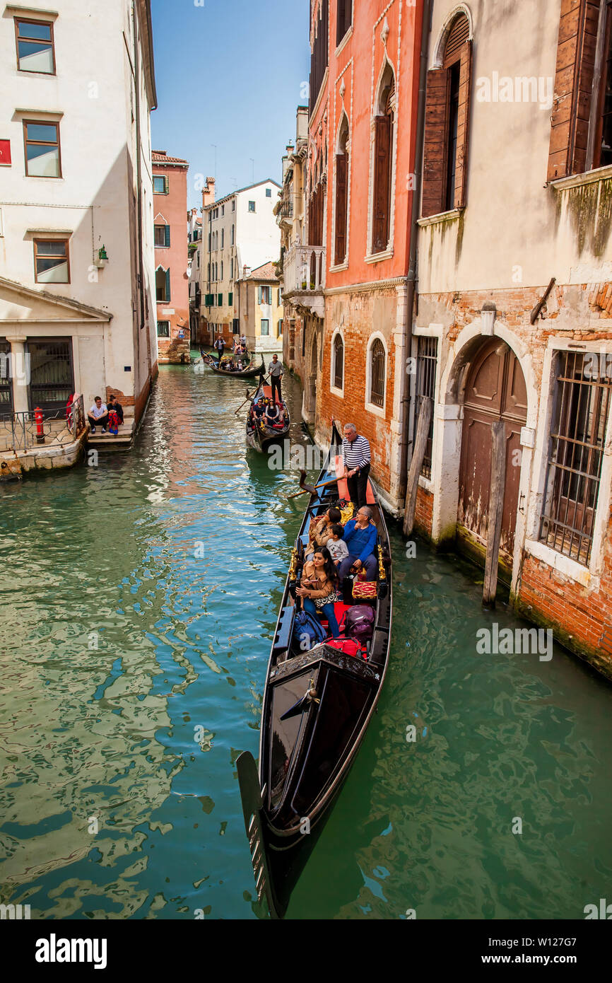 VENICE, ITALY - APRIL, 2018: Tourists sailing in a gondola on the ...