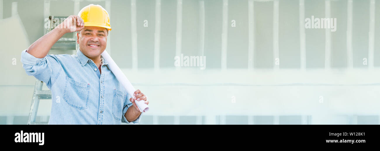 Hispanic Male Contractor Wearing Hard Hat Against Drywall Banner ...