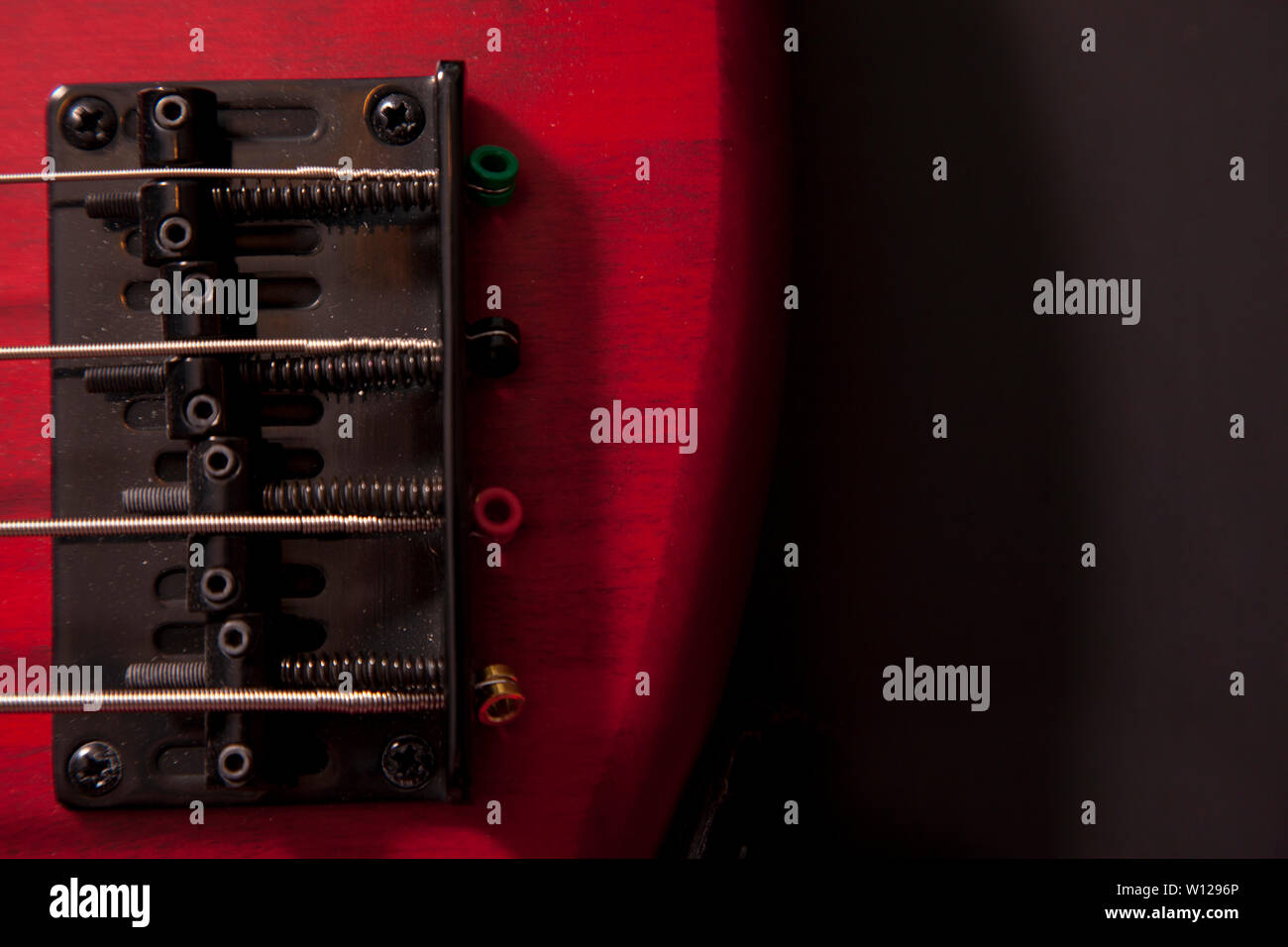 bottom of a red bass guitar showing the bridge connections Stock Photo ...