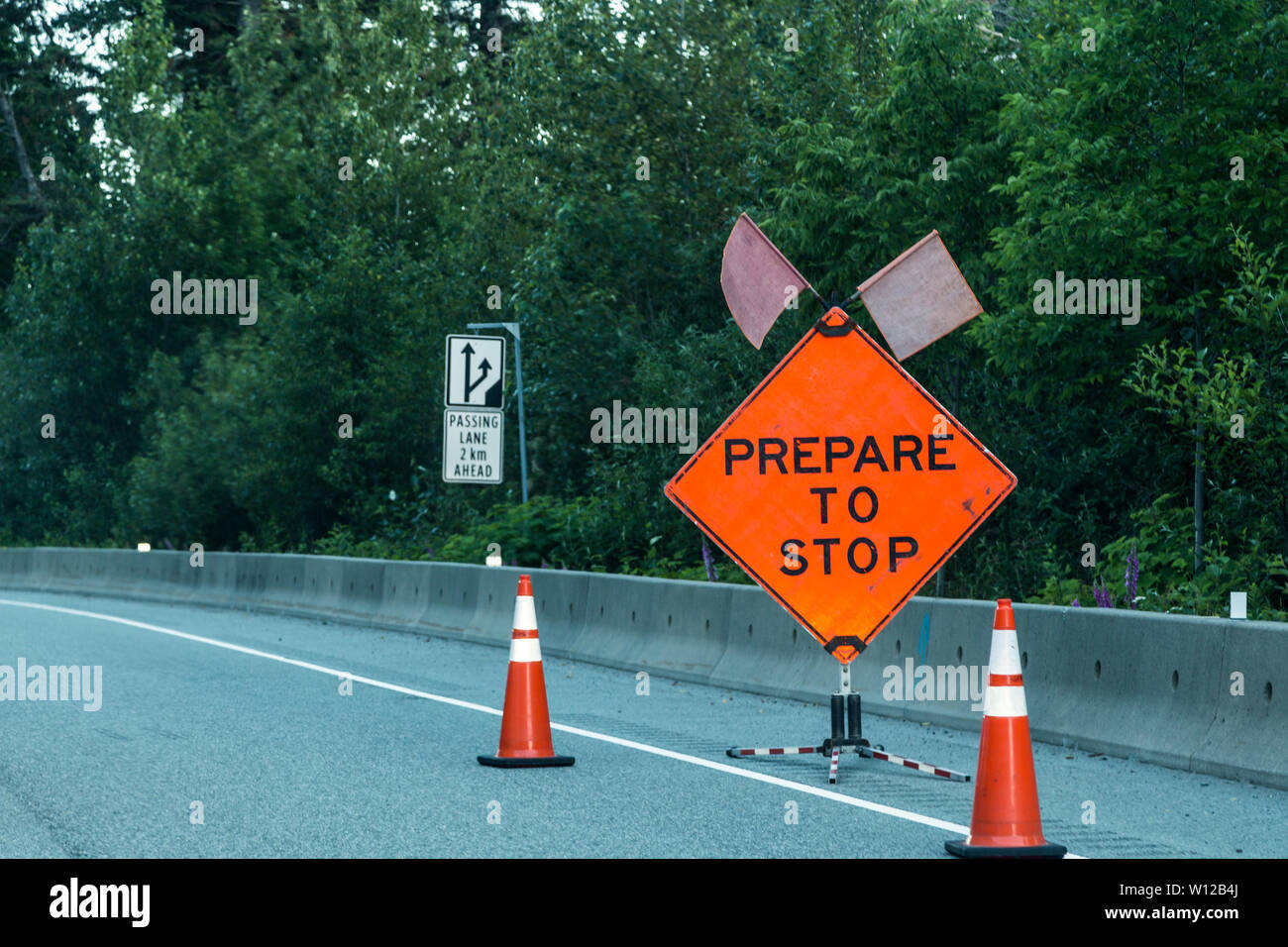 Bright orange sign that reads be prepared to stop warns a line of ...