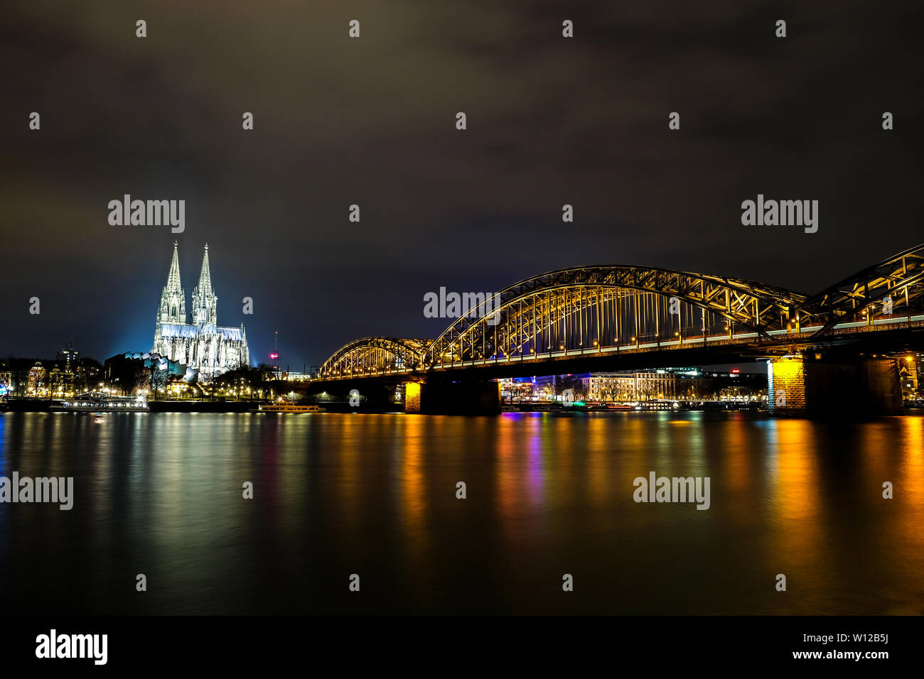 Cologne Cathedral and Hohenzollern Bridge at night in Cologne, Germany ...