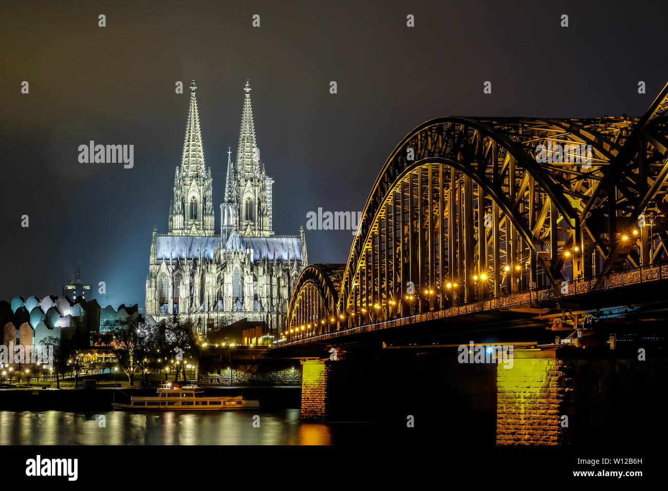 Cologne Cathedral and Hohenzollern Bridge at night in Cologne, Germany ...