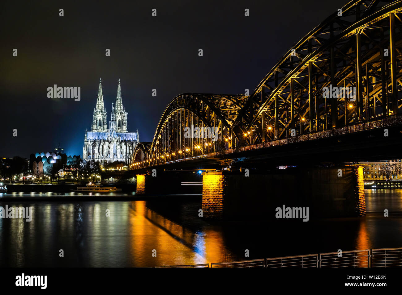 Cologne Cathedral and Hohenzollern Bridge at night in Cologne, Germany ...