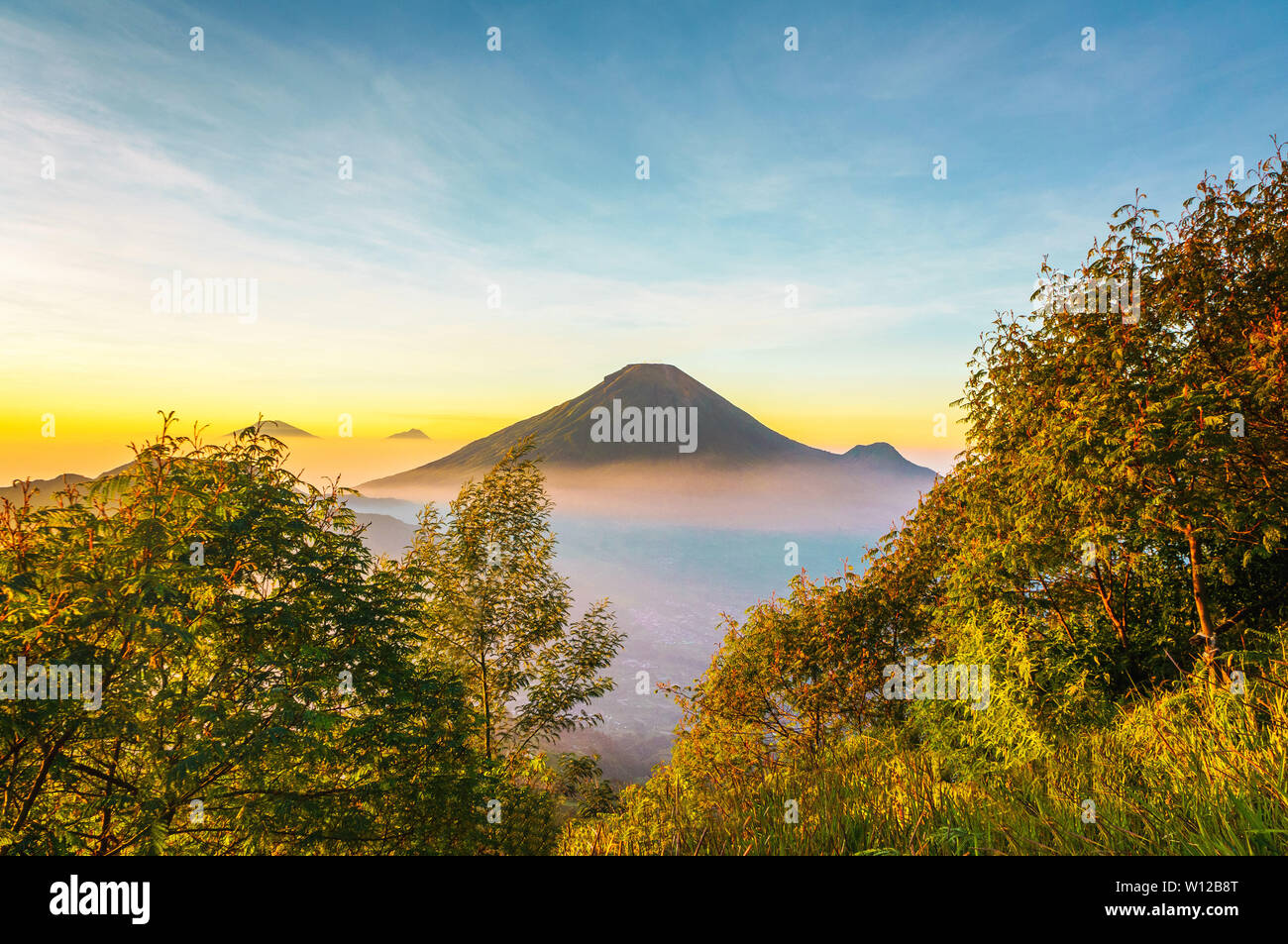 Sunrise with Sindoro mountain view from Pakuwojo Hill, Dieng, Wonosobo ...