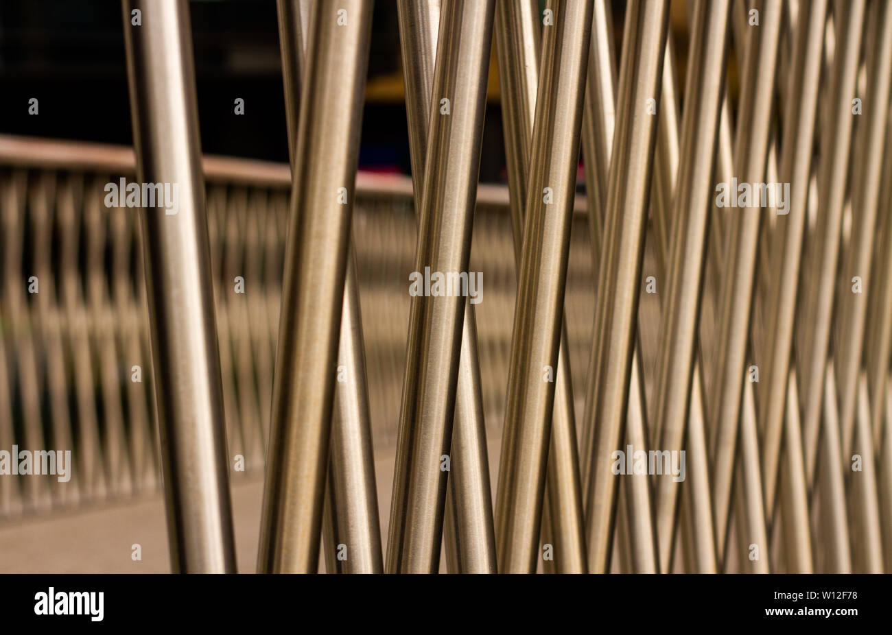 Brushed chrome metal bars slanted diagonally forming an x seen as a ...