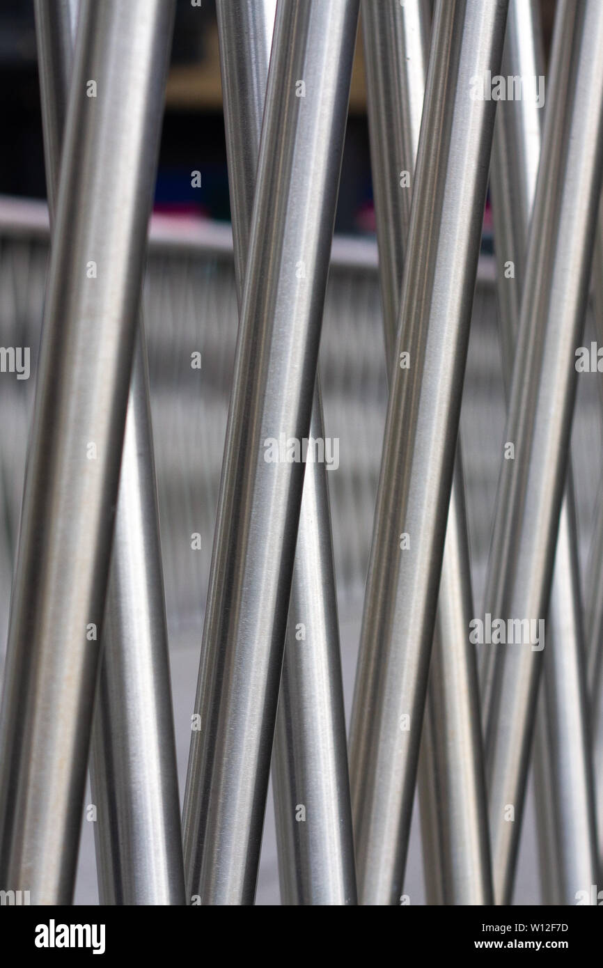 Brushed chrome metal bars slanted diagonally forming an x seen as a ...