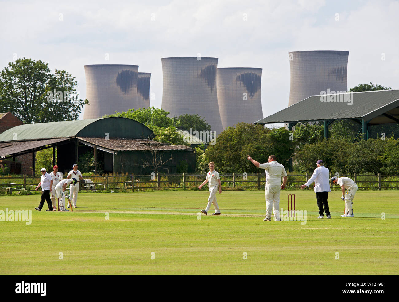 Cricket match in progress in the village of Drax, overlooked by the ...