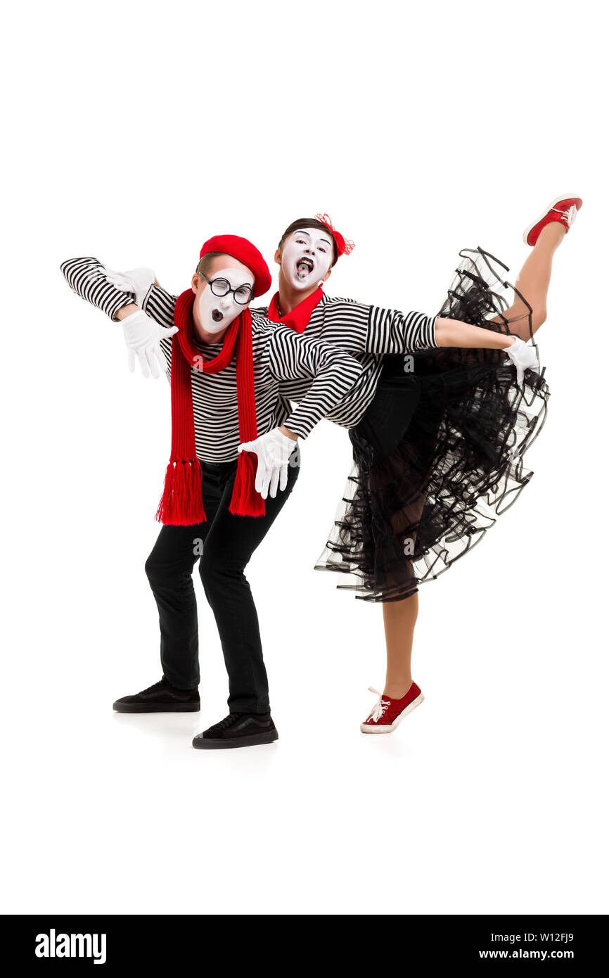 mimes in striped shirts. Male and female mimes dancing with wide open ...