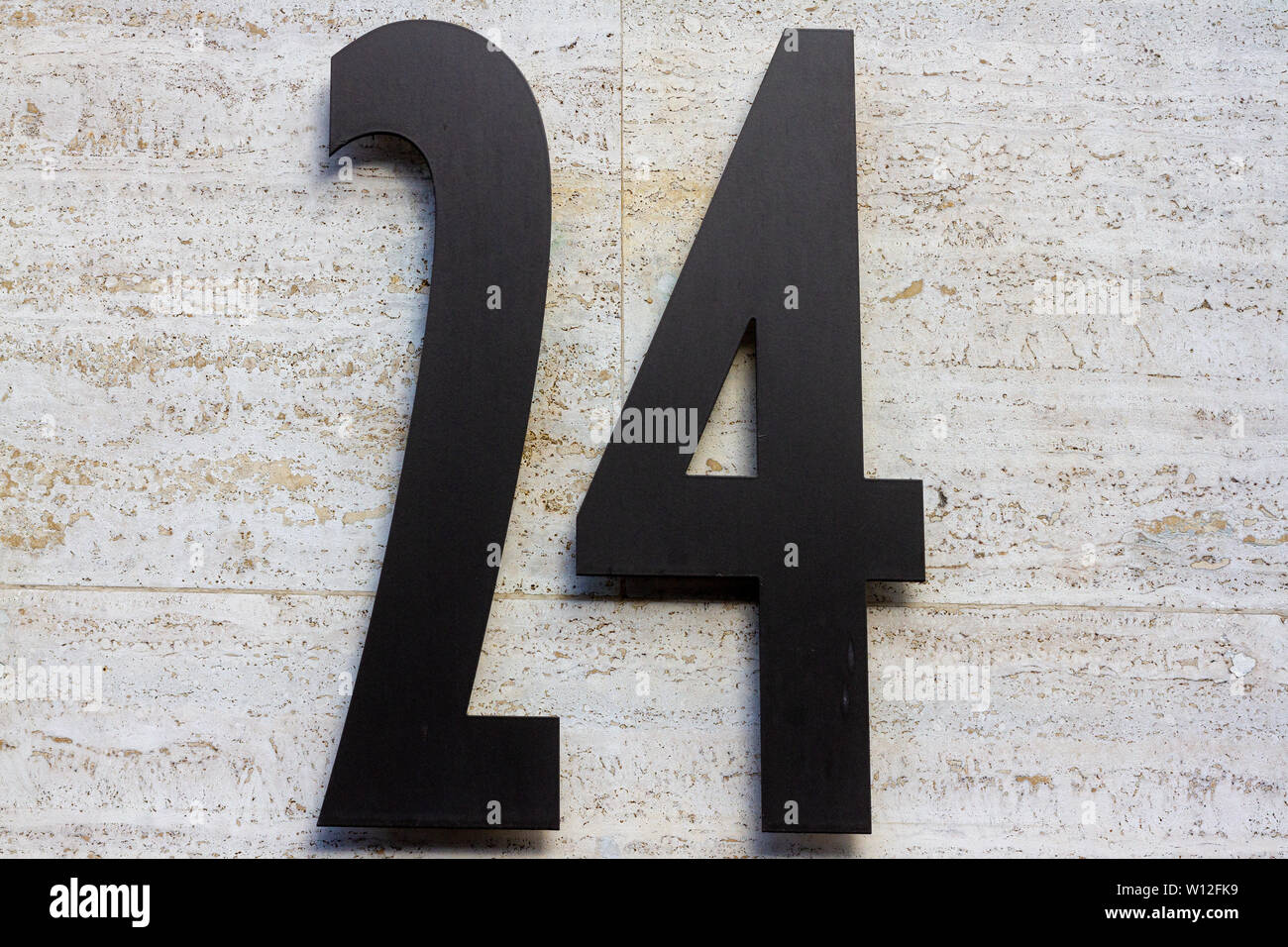 Large house number 24 in black on white marble Stock Photo - Alamy