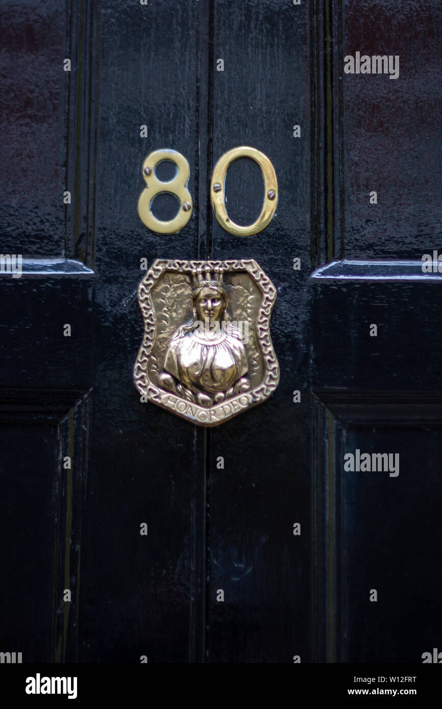 House number 80 with a bronze plaque with a female - a crowned queen on ...
