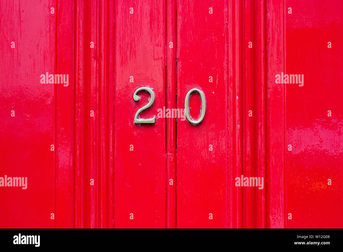 House number 20 with a golden twenty on a bright red door Stock Photo ...