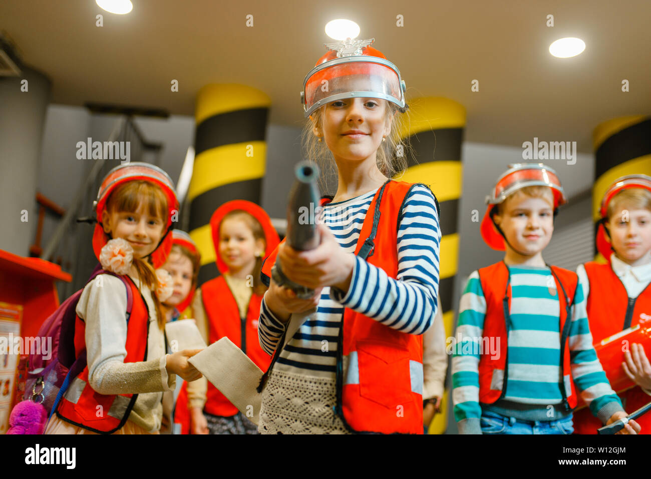 Child with hose in hands playing firefighter Stock Photo - Alamy