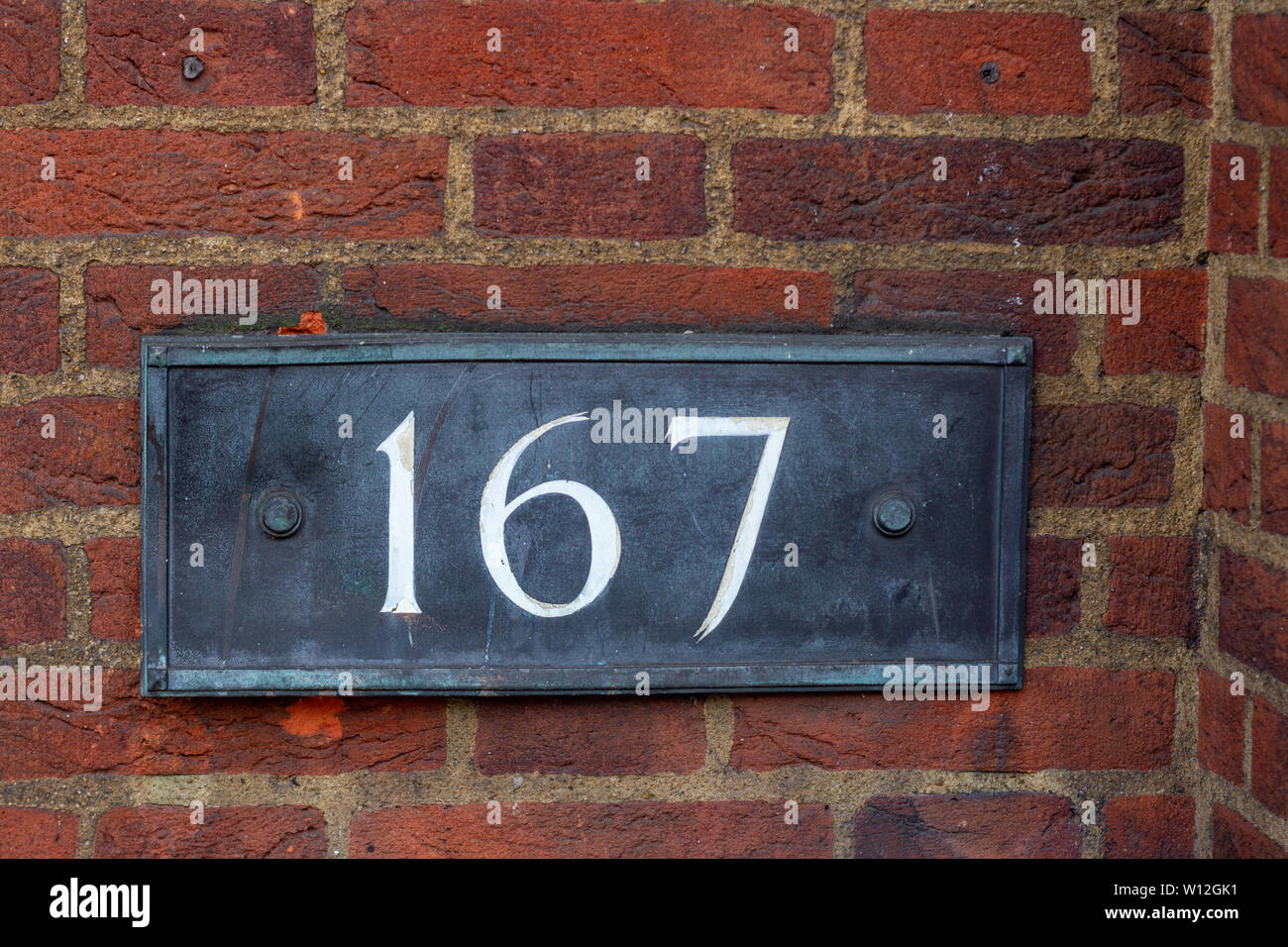 House number 167 on black slate on a red brick wall Stock Photo - Alamy