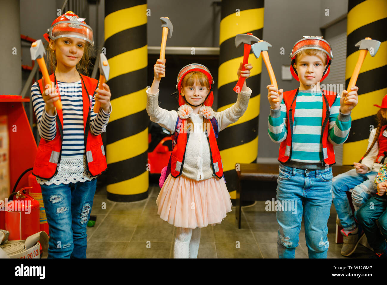Children with tools in hands playing firefighters Stock Photo - Alamy