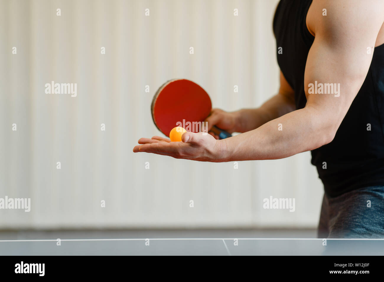 Man with ping pong racket preparing to hit a ball Stock Photo - Alamy