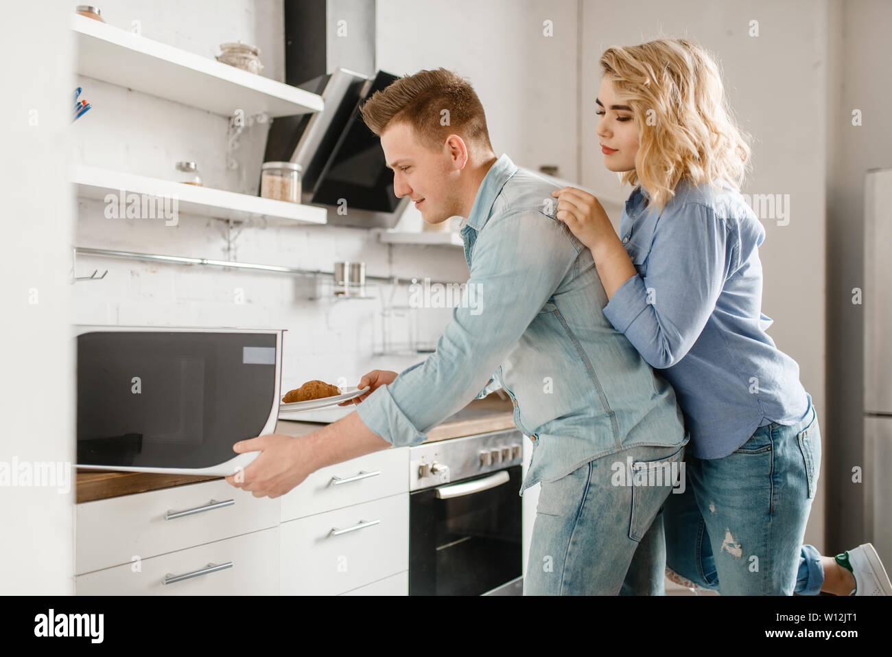 Young couple prepares meal together hi-res stock photography and images ...
