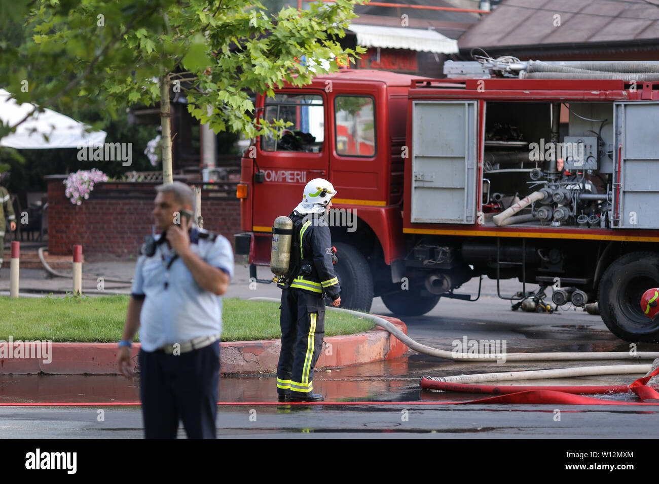 Bucharest, Romania - June 29, 2019: Firefighters try to extinguish a ...