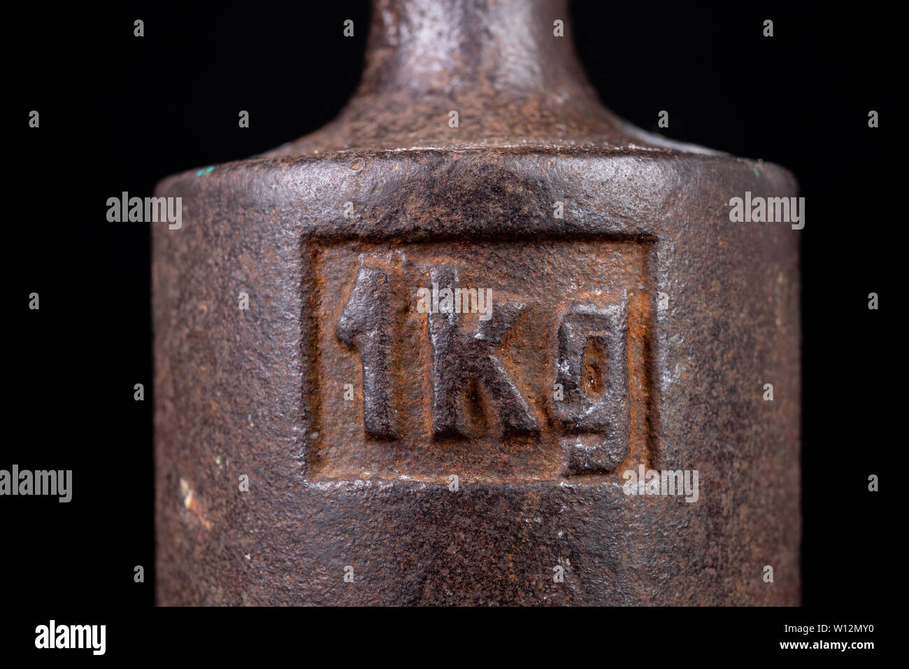 Old kilo weights on books. Old books and weighing machines. Dark ...