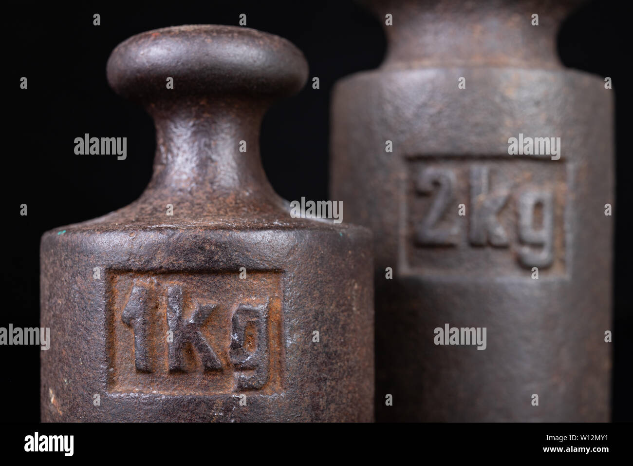 Old kilo weights on books. Old books and weighing machines. Dark ...