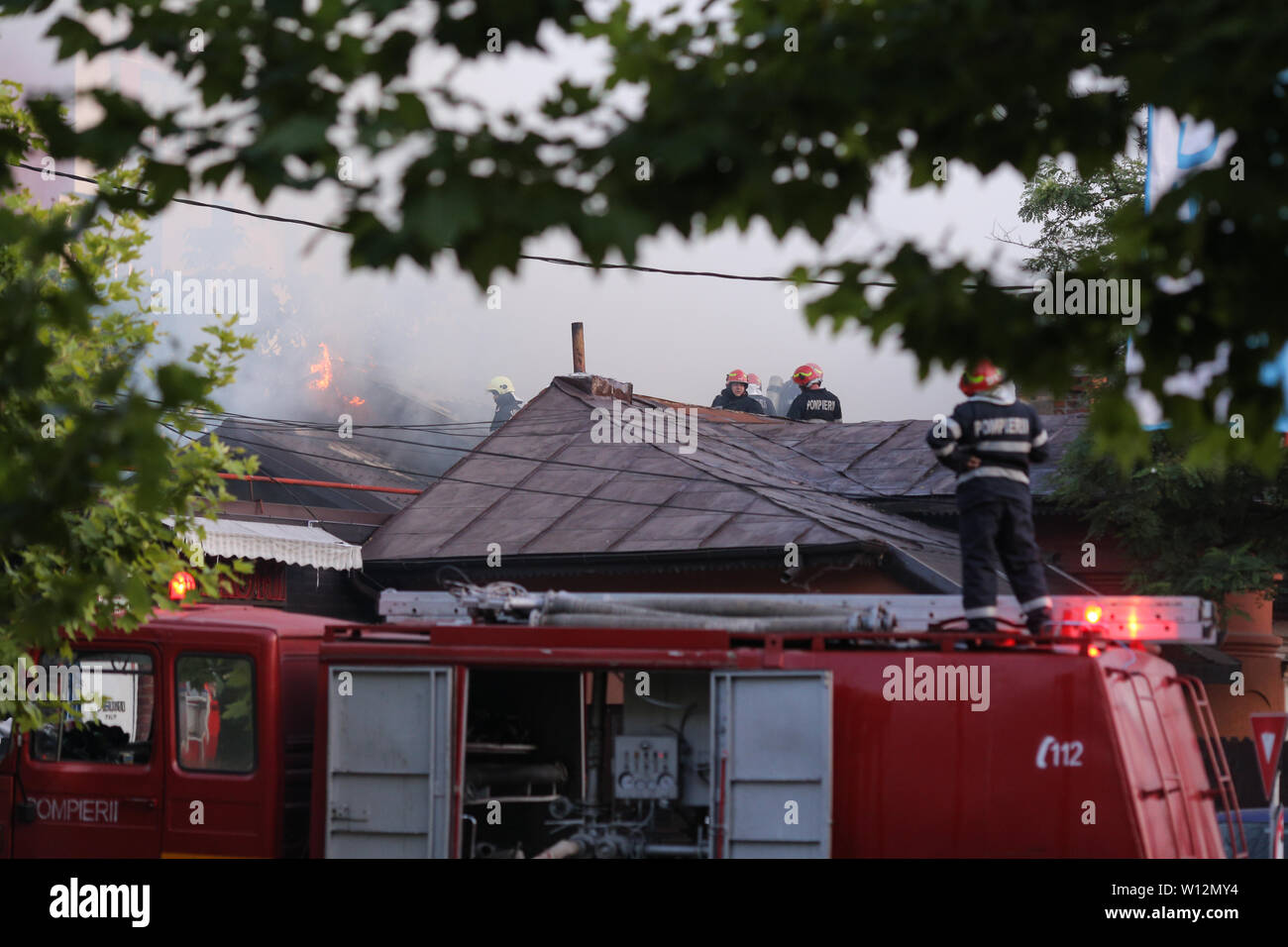 Bucharest, Romania - June 29, 2019: Firefighters try to extinguish a ...