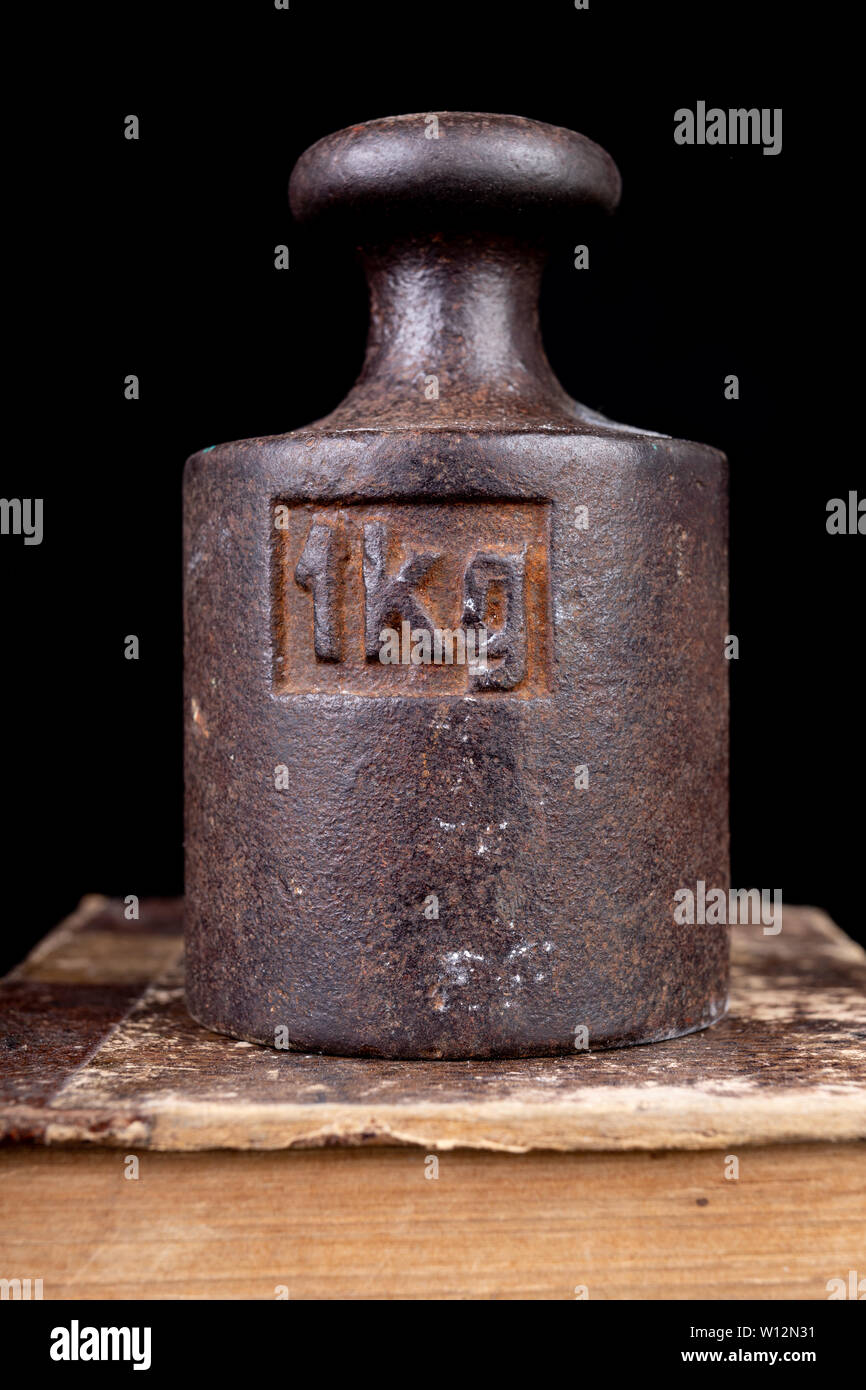 Old kilo weights on books. Old books and weighing machines. Dark ...