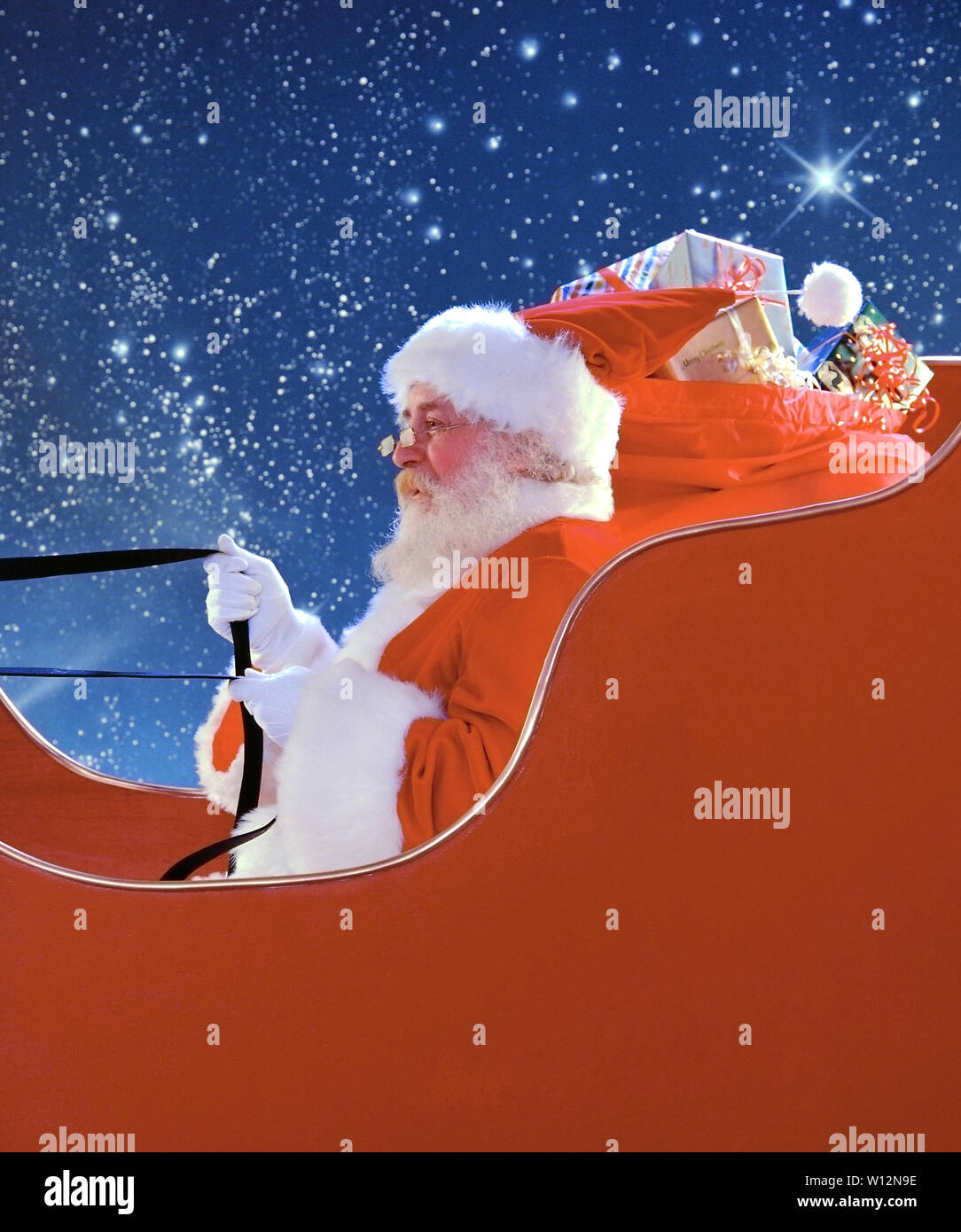Santa driving his sled Stock Photo - Alamy