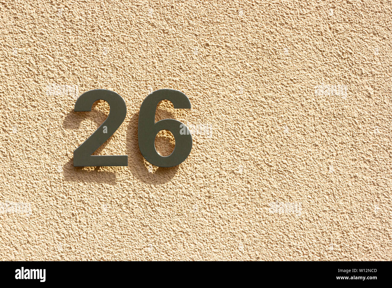 House number 26 with the twenty-six in silver metal digits throwing a ...