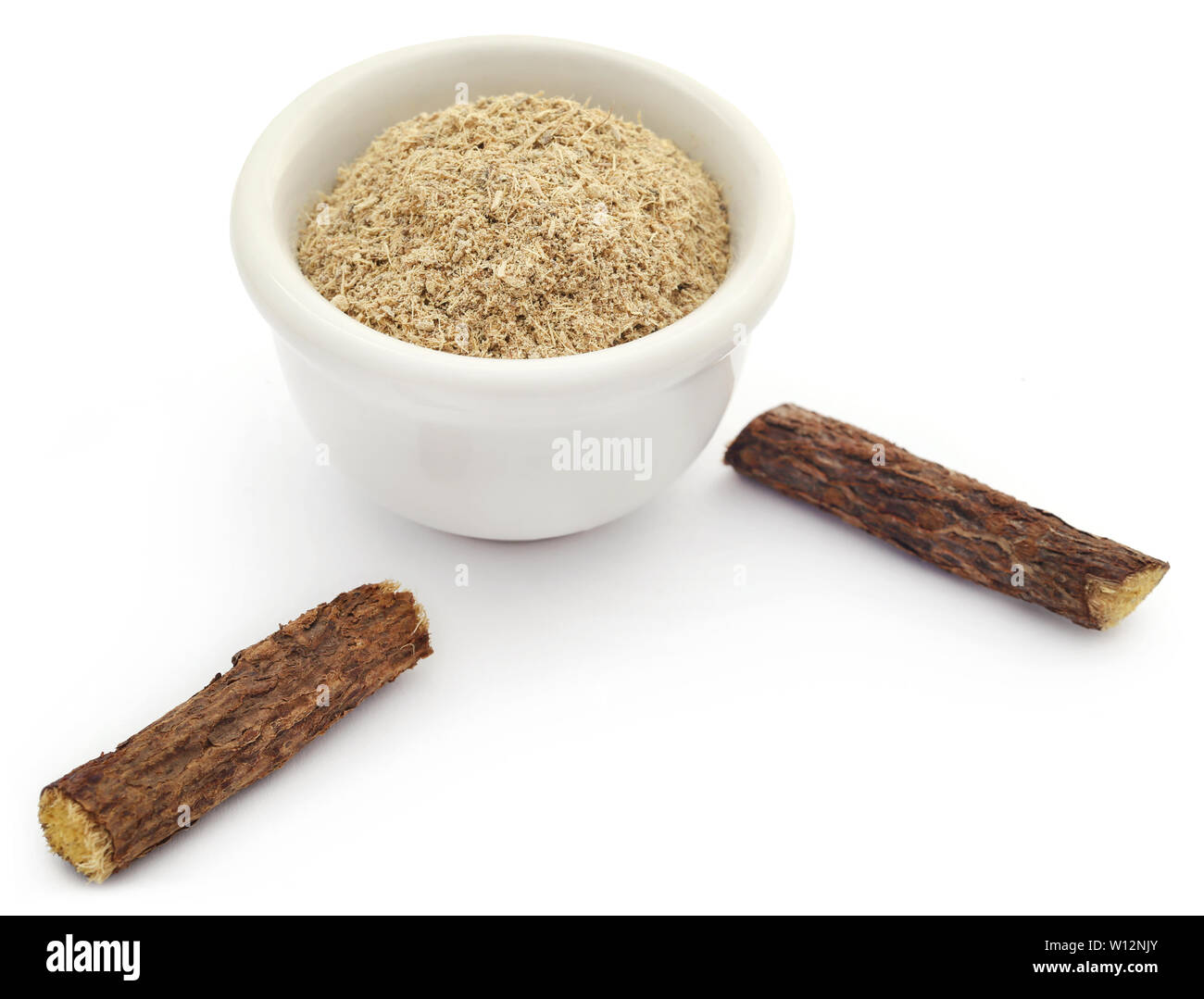 Liquorice with powder in a bowl over white Stock Photo - Alamy