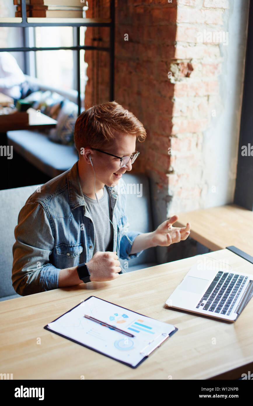 Man in glasses moving hands while having a conversation and working at ...