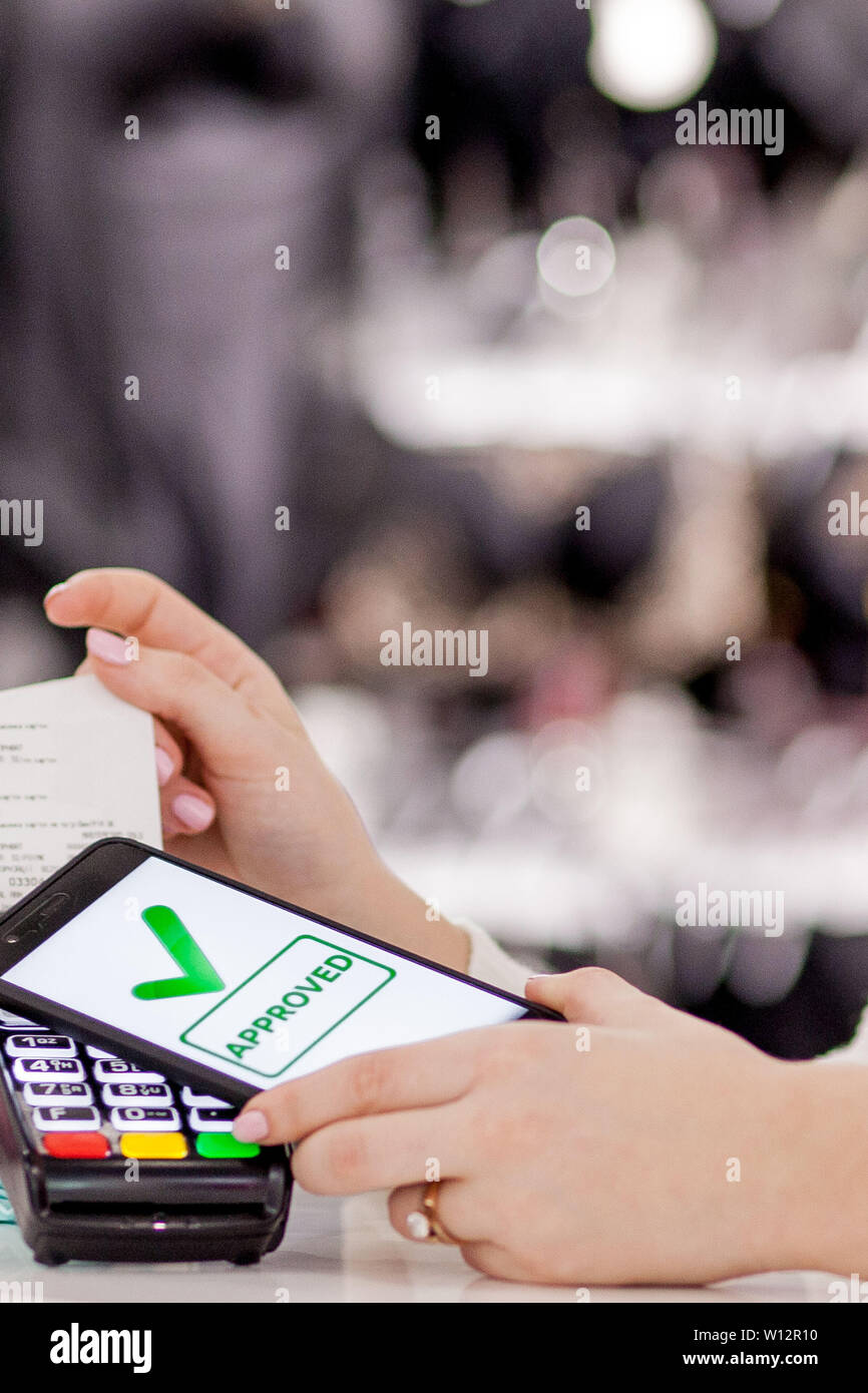 POS terminal, Payment Machine with mobile phone on store background ...