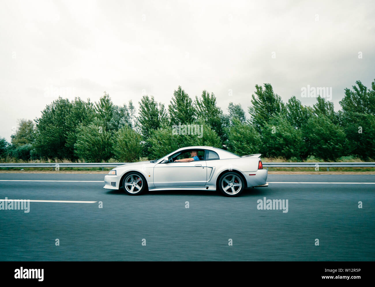 Germany - Aug 15, 2018: Carefree adult man driving silver coupe sport ...