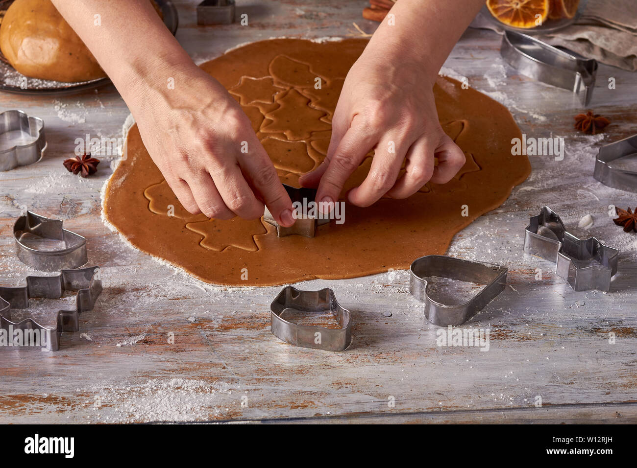 Woman's hands make gingerbread cookies shapes for baking Stock Photo ...