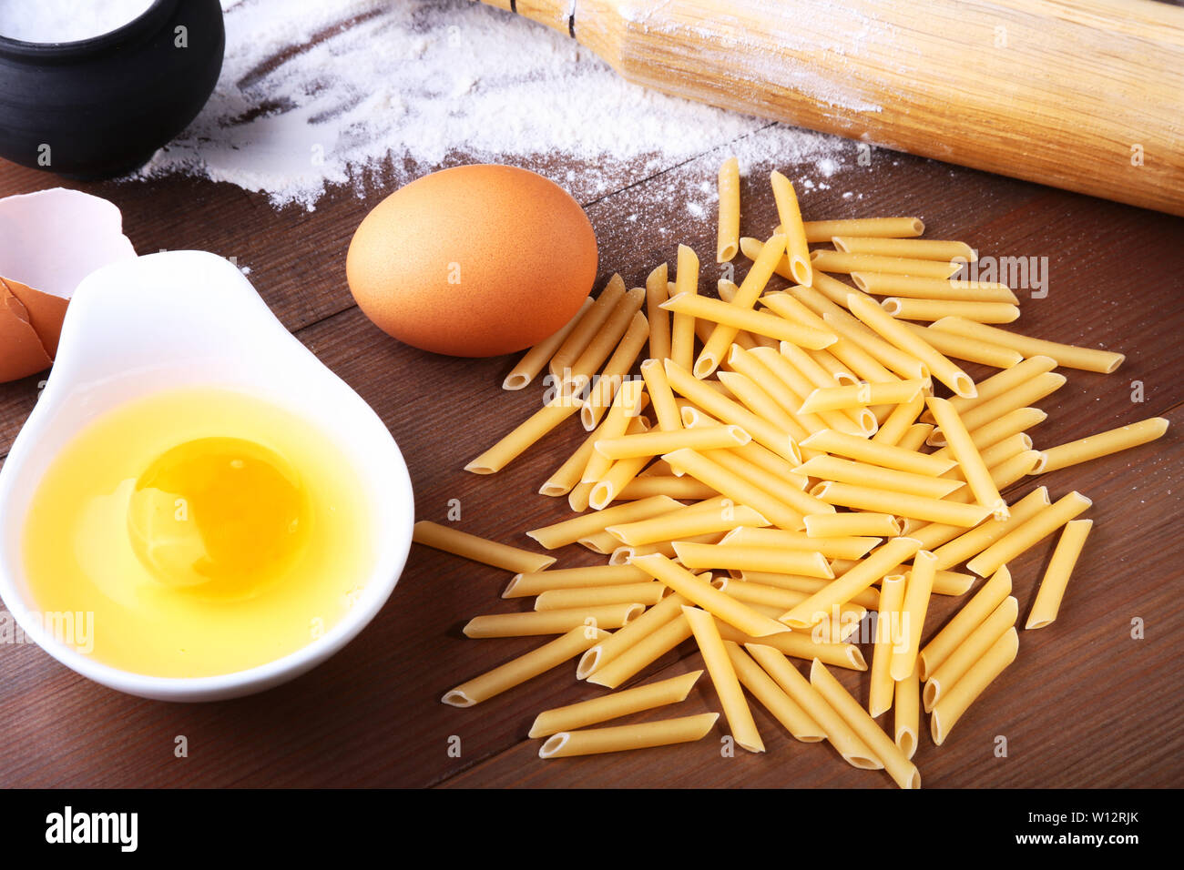 egg, flour, salt, ingredients for pasta penne bolognese Stock Photo - Alamy