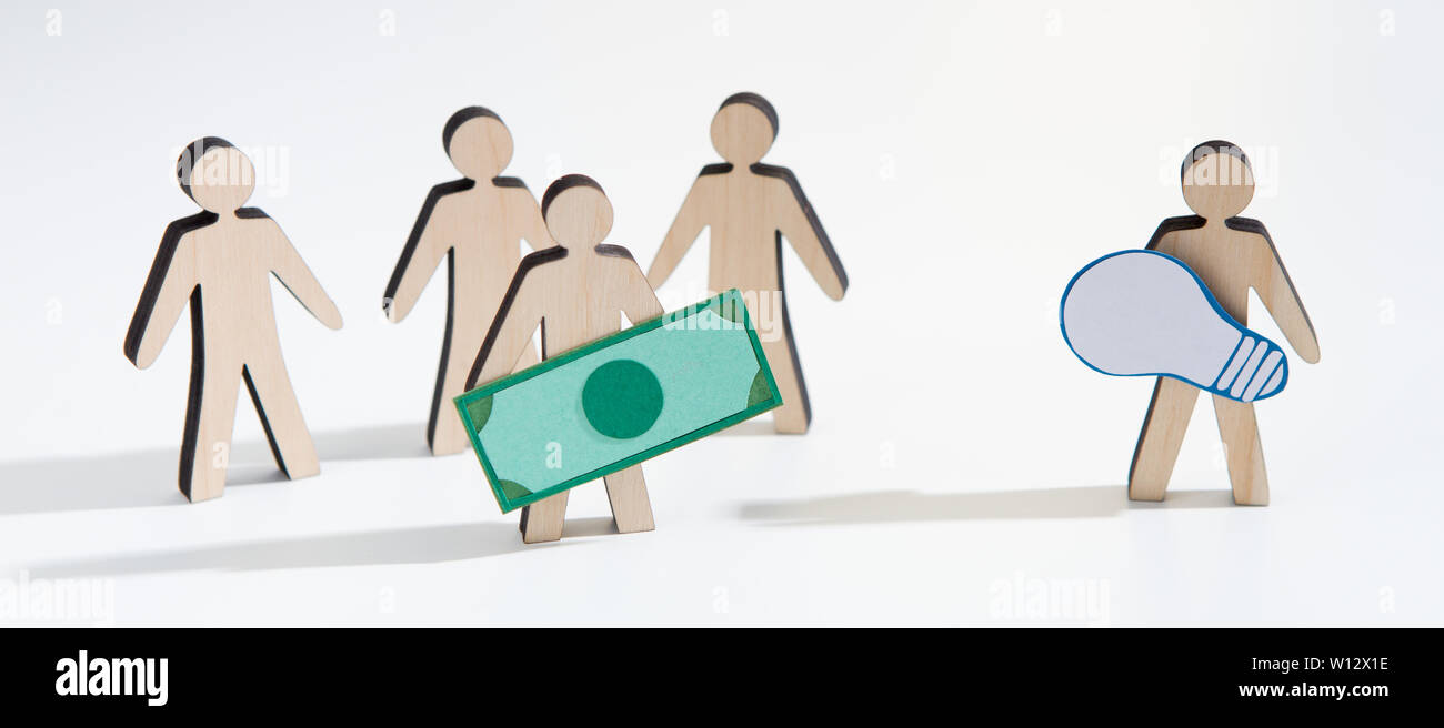 Wooden people with money helping young enterpreneur Stock Photo - Alamy