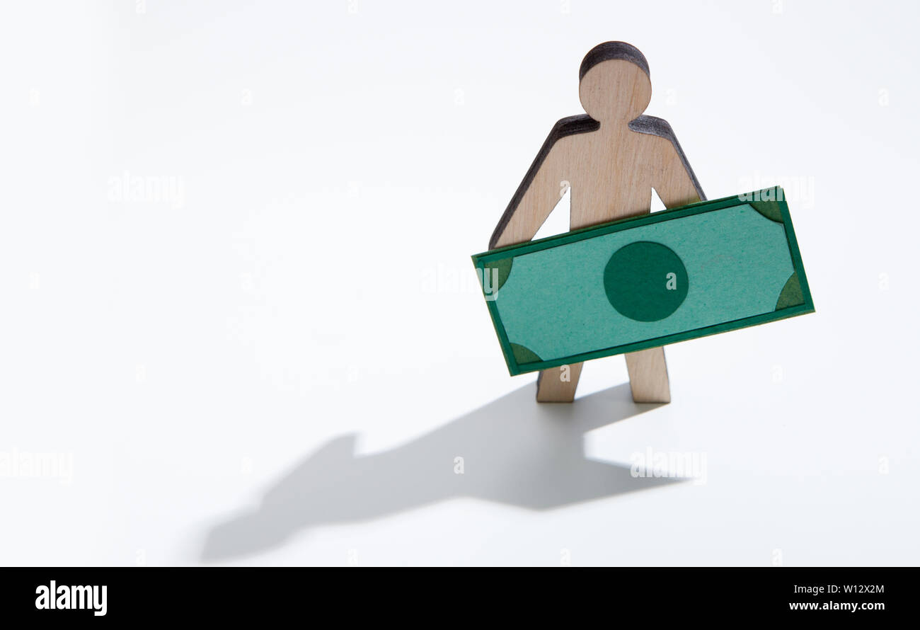 Wooden man with dollars standing on white background Stock Photo - Alamy