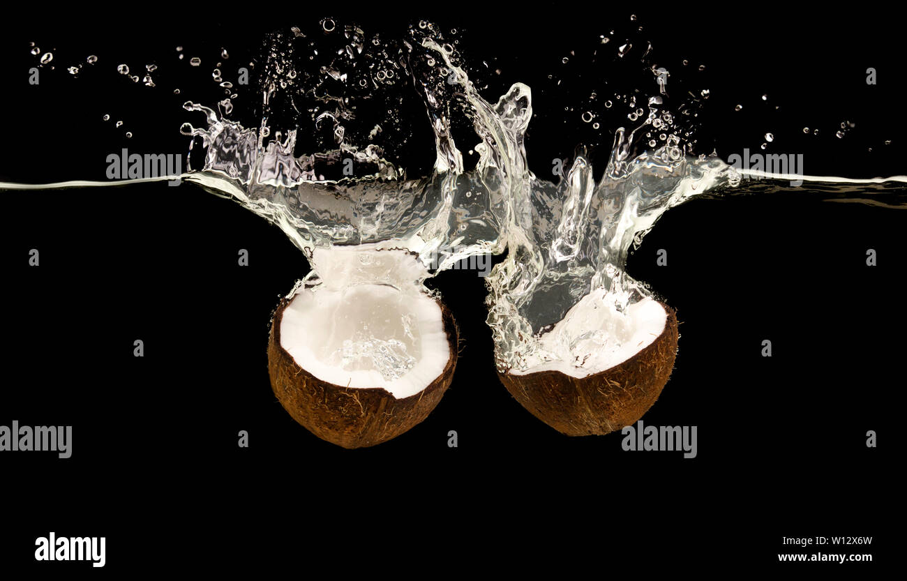 Ripe coconut halves with clear water splash and drops Stock Photo - Alamy