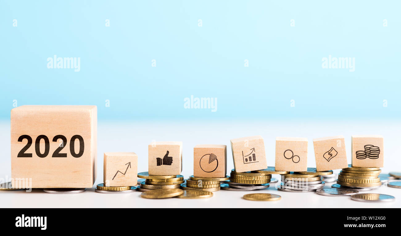 Wooden blocks with coins, dollar, graphs laying on real money Stock ...