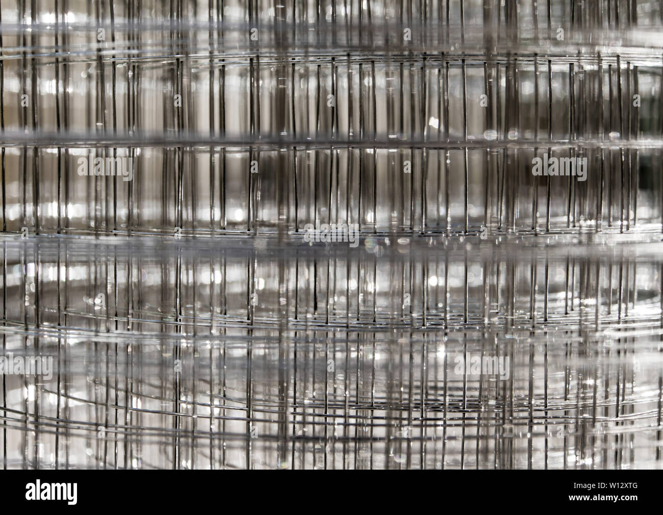 Roll loose shiny thin steel wire grating Stock Photo - Alamy