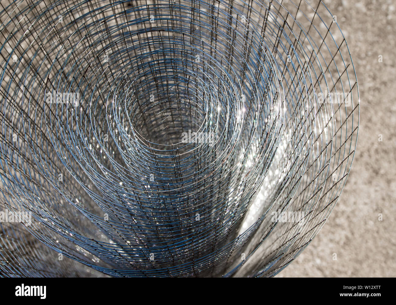 Roll loose shiny thin steel wire grating Stock Photo - Alamy