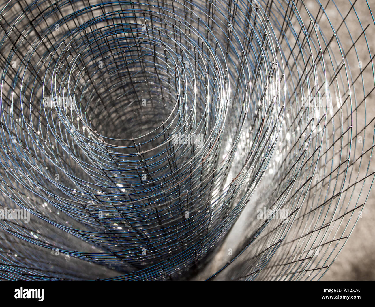 Roll loose shiny thin steel wire grating Stock Photo - Alamy