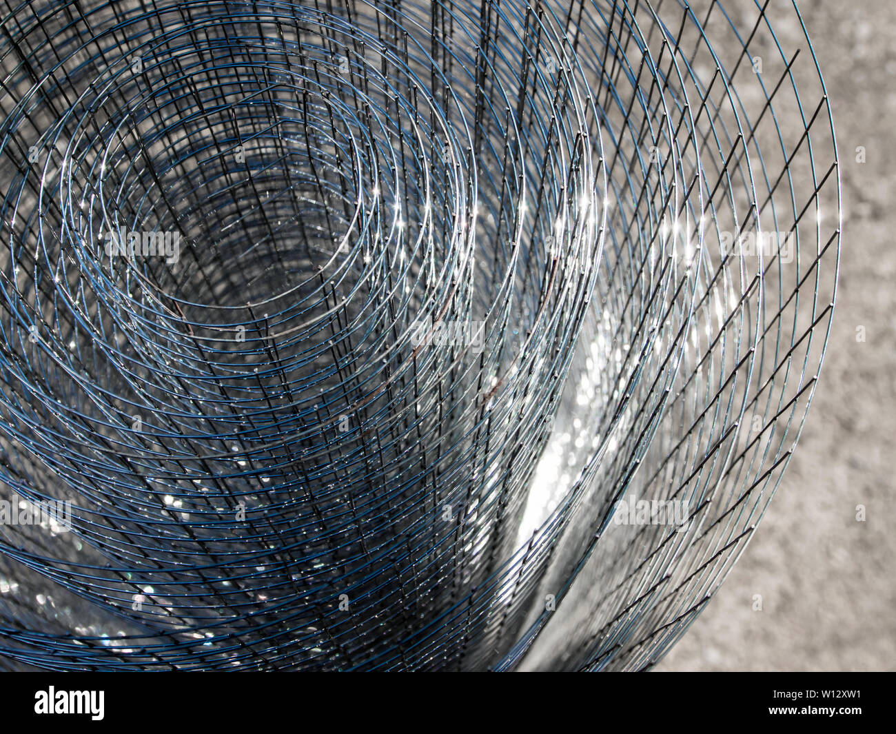 Roll loose shiny thin steel wire grating Stock Photo - Alamy
