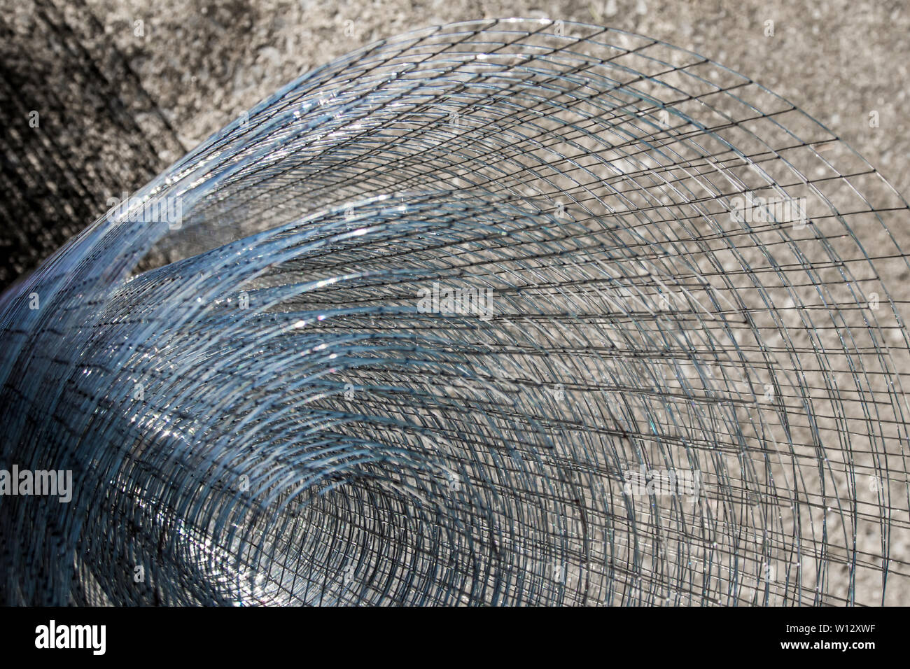 Roll loose shiny thin steel wire grating Stock Photo - Alamy