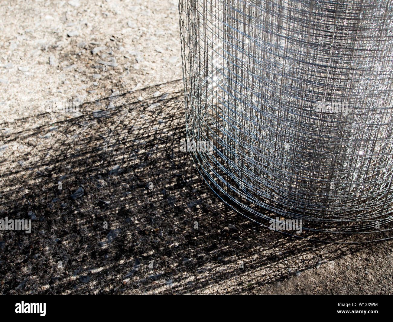 Roll loose shiny thin steel wire grating Stock Photo - Alamy