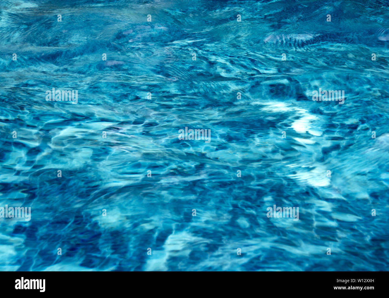 Reflection of sunlight and blue sky on the moving water surface in the ...