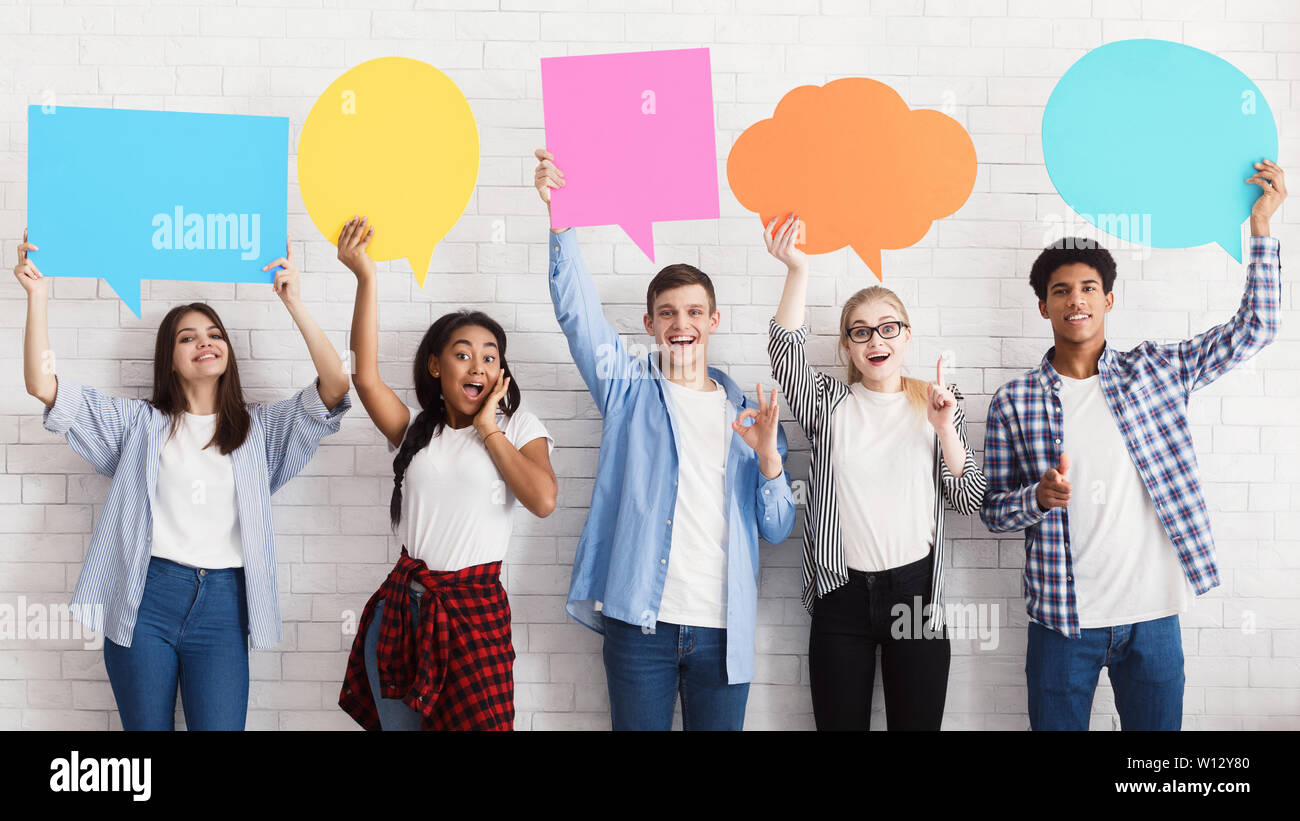 Speech bubbles. Happy friends holding empty placards Stock Photo - Alamy